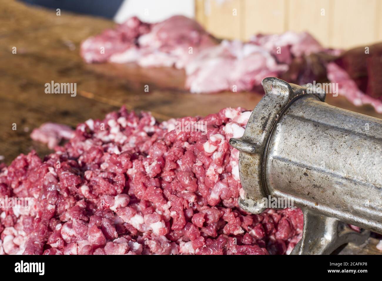 Iron meat grinder grinding beef in the kitchen Stock Photo - Alamy