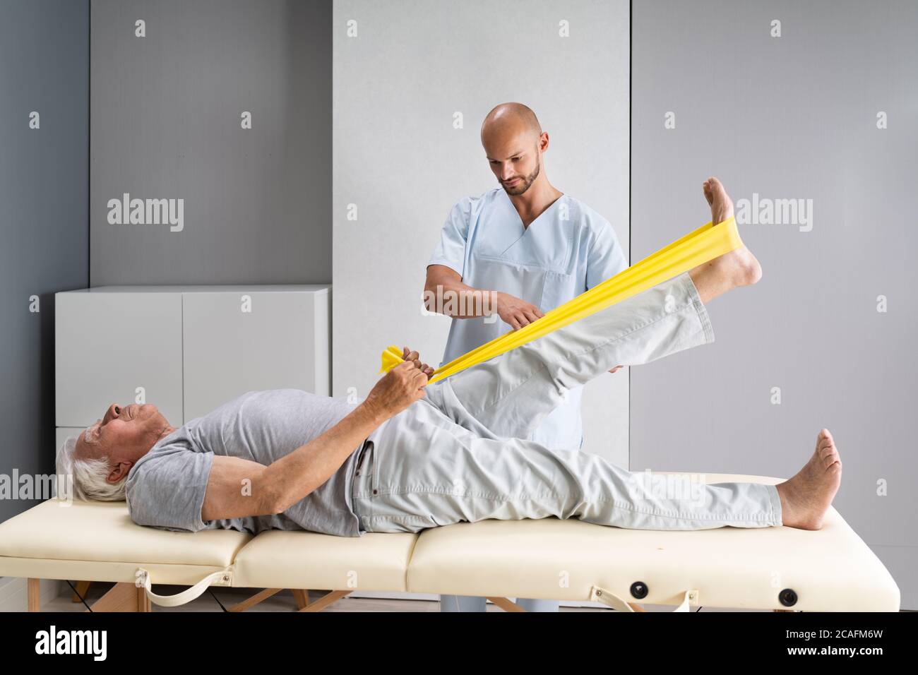 Knee Exercise Therapy And Treatment Using Physical Band Stock Photo - Alamy