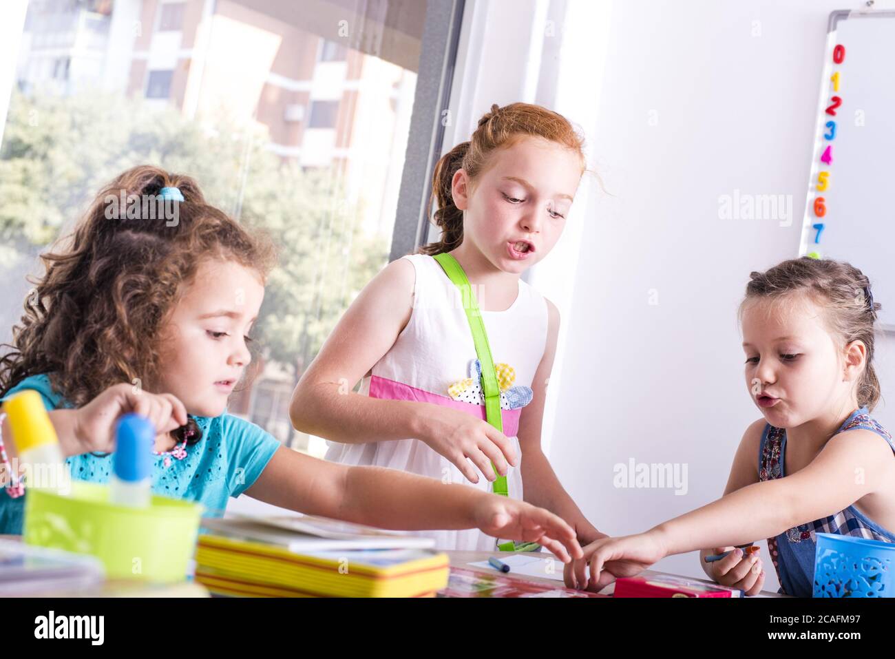 Group of happy little school kids in the classroom Stock Photo - Alamy