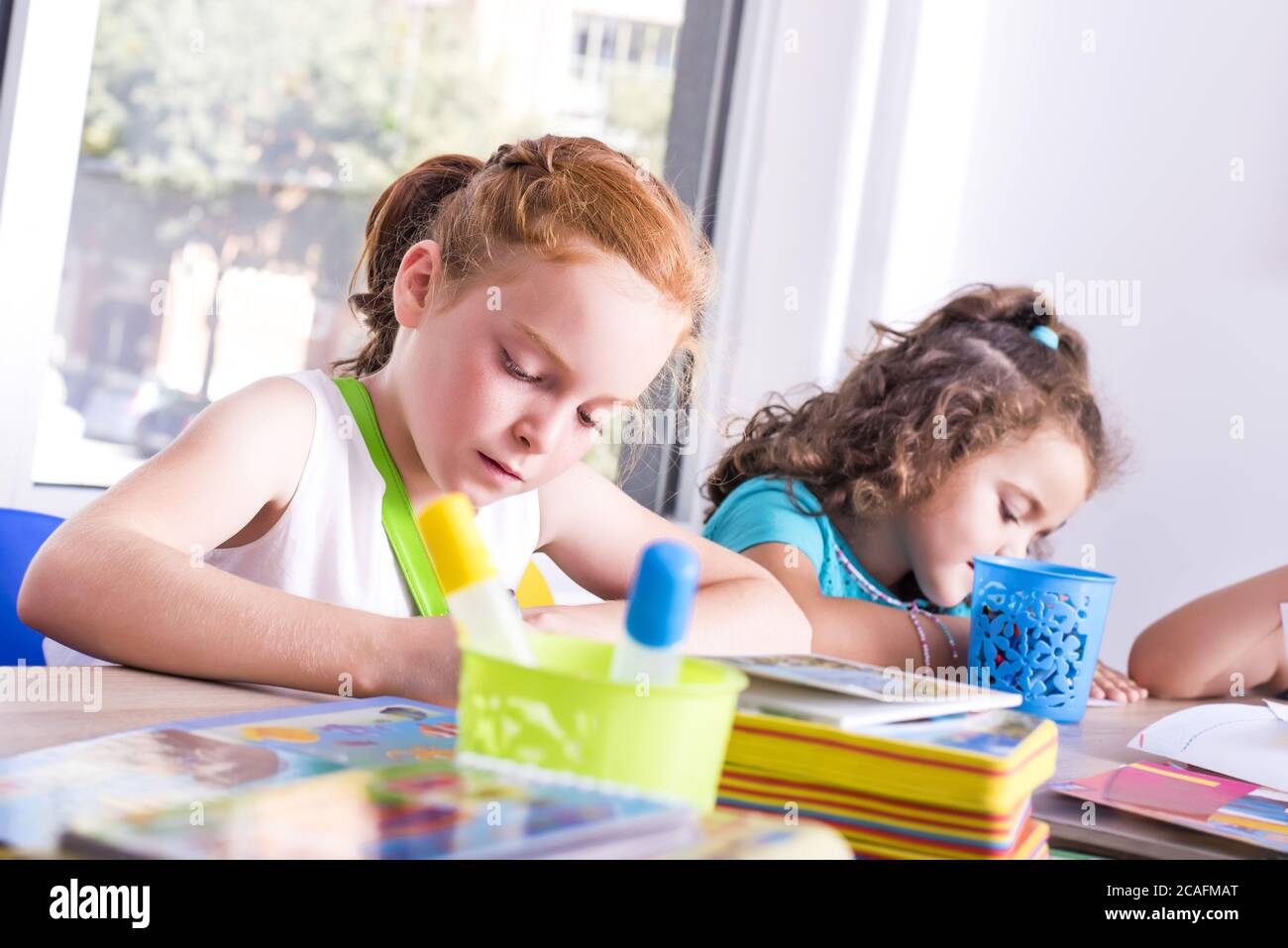 Group of happy little school kids in the classroom Stock Photo - Alamy