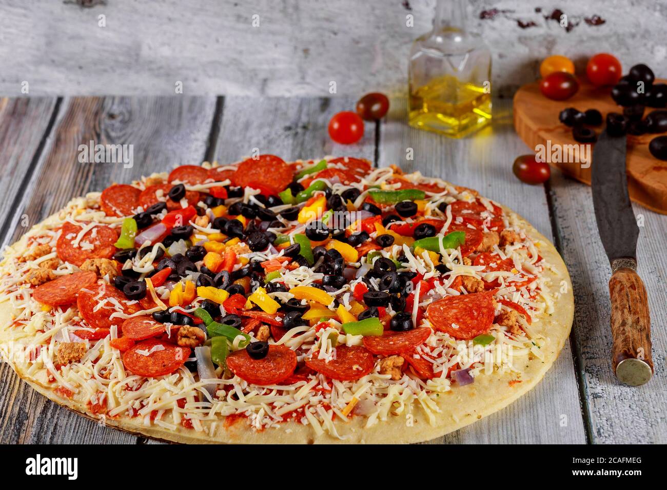 Round pizza with pepperoni, sausage, olives, pepper onion and cheese ...