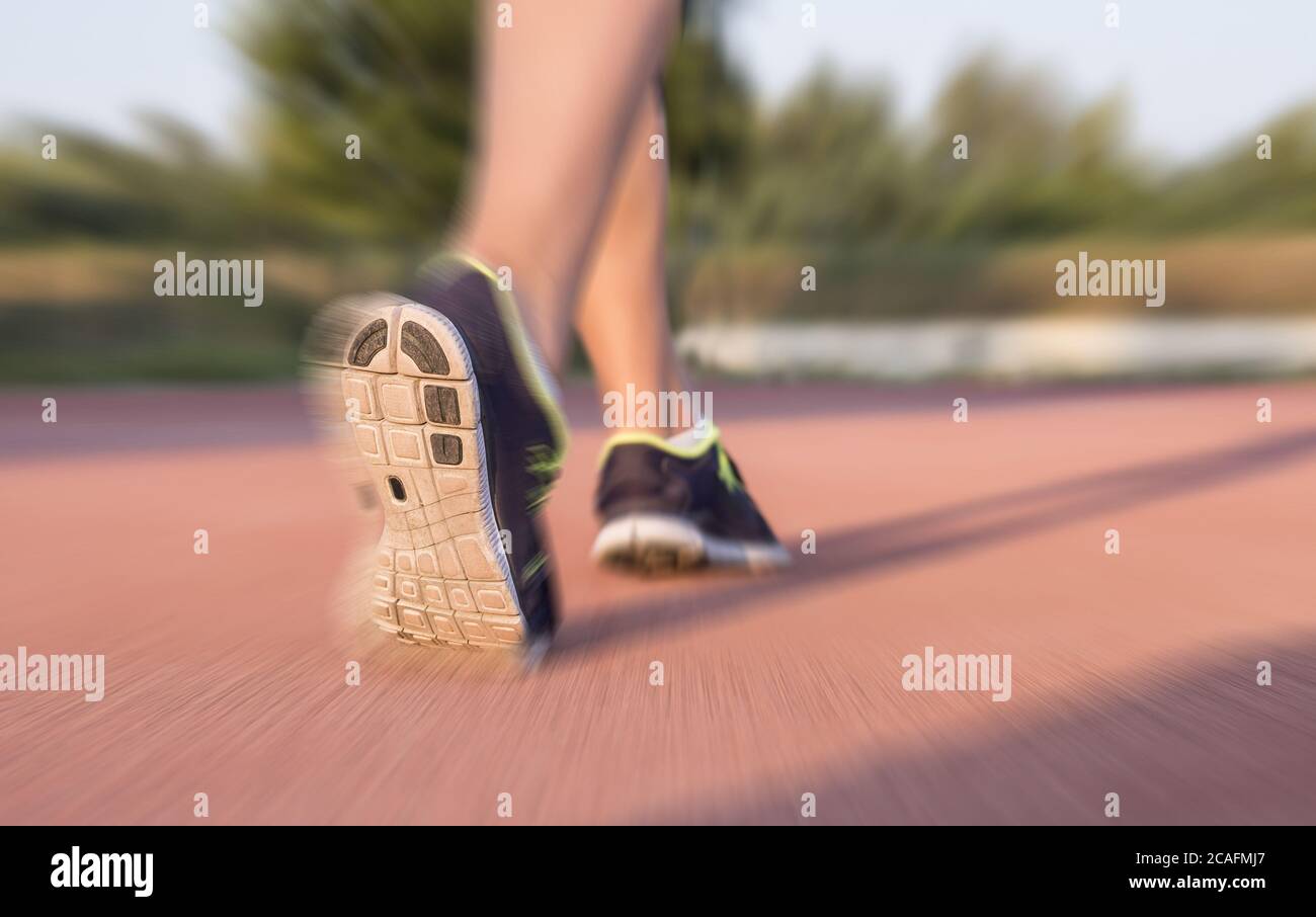 Closeup blurred shot of female feet while running Stock Photo - Alamy