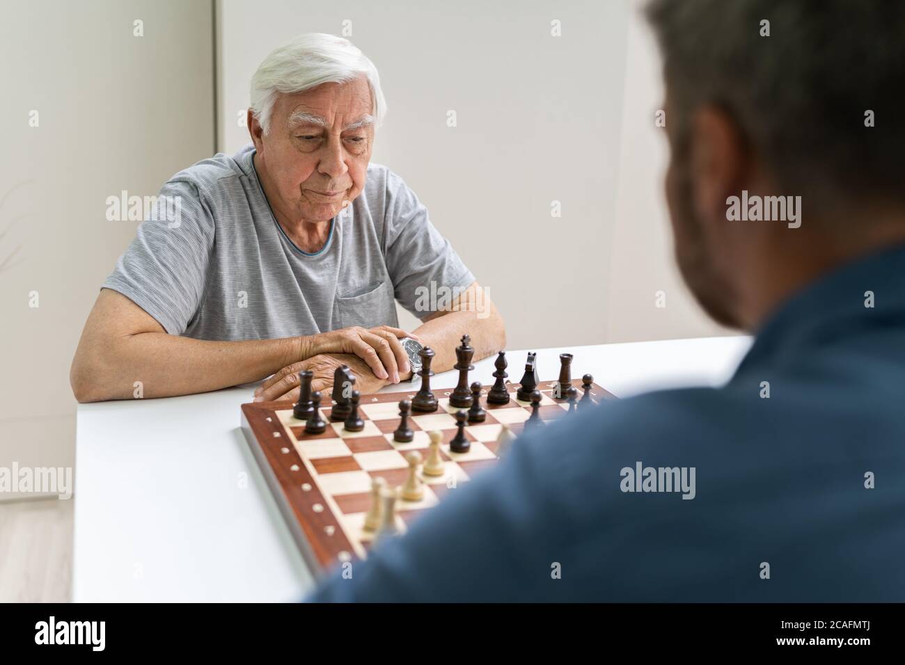 Elderly Senior Playing Chess Table Board Game Stock Photo - Alamy
