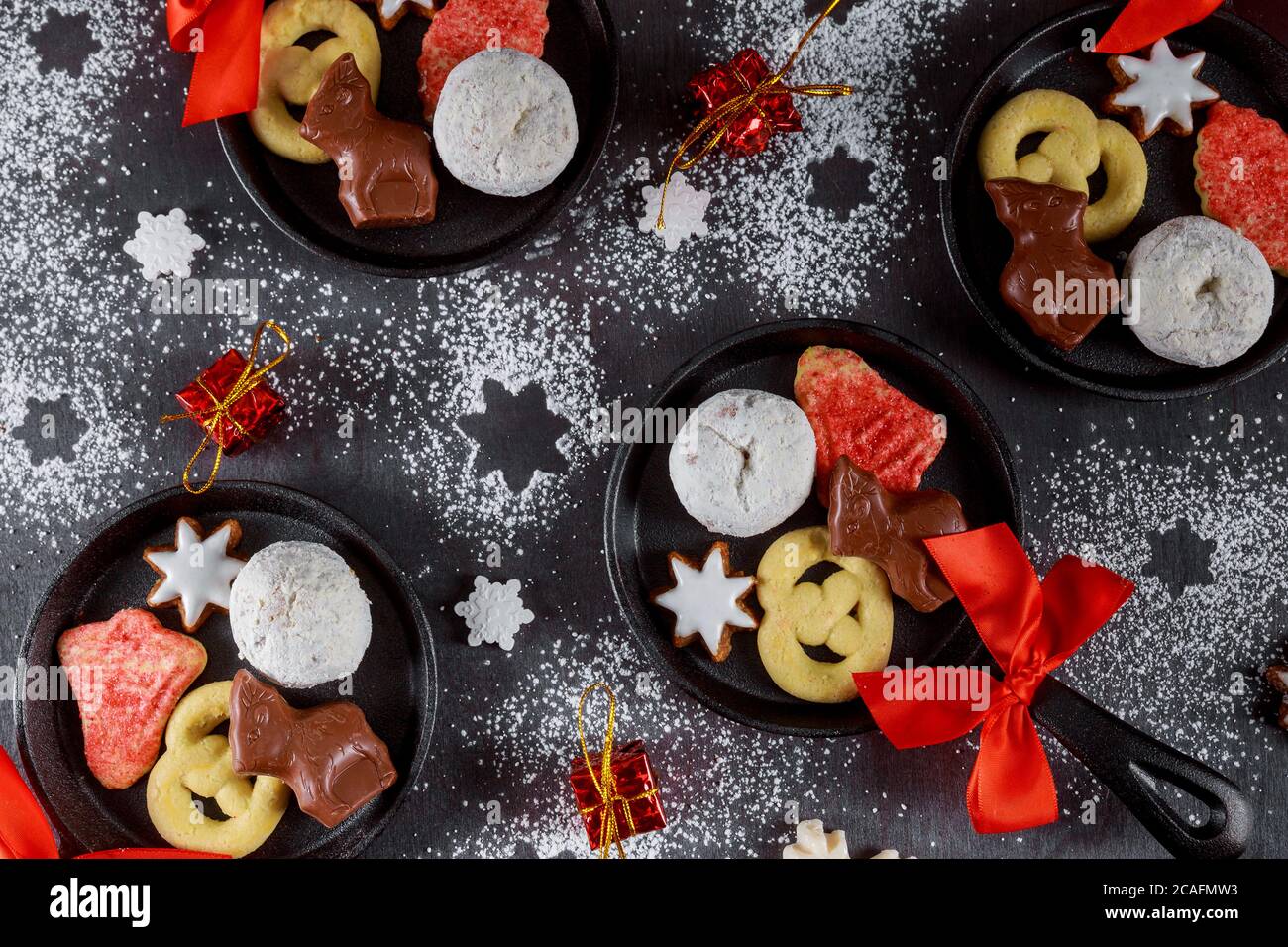 Top view of mini iron skillets. Christmas cookie, chocolate and ...