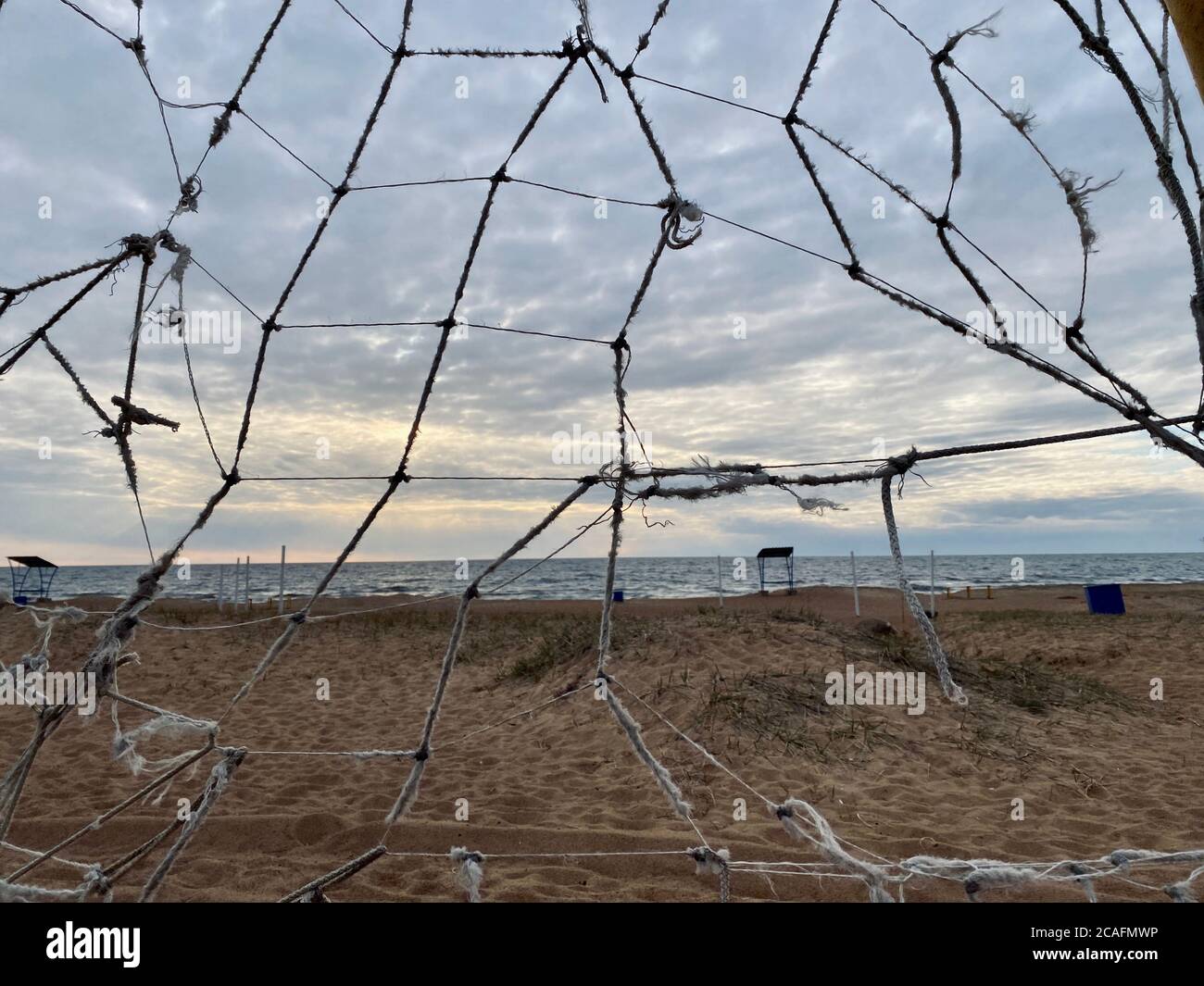 old torn soccer net on a deserted beach Stock Photo - Alamy