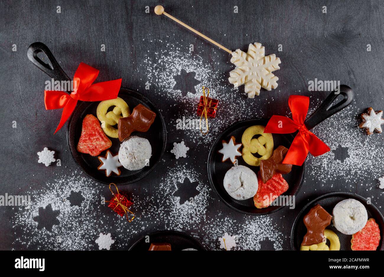 Top view of mini iron skillets. Christmas cookie, chocolate and ...