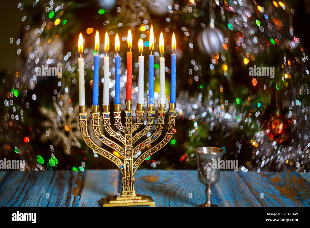 Hanukkah background with menorah and burning candles on sparkle ...
