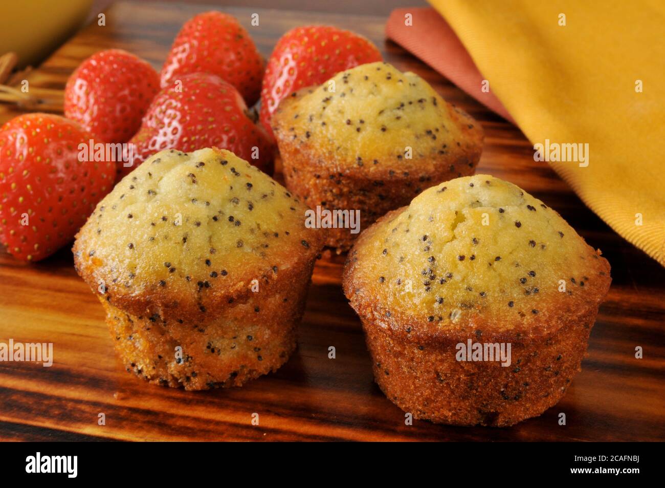 Poppyseed mini muffins with fresh strawberries Stock Photo - Alamy