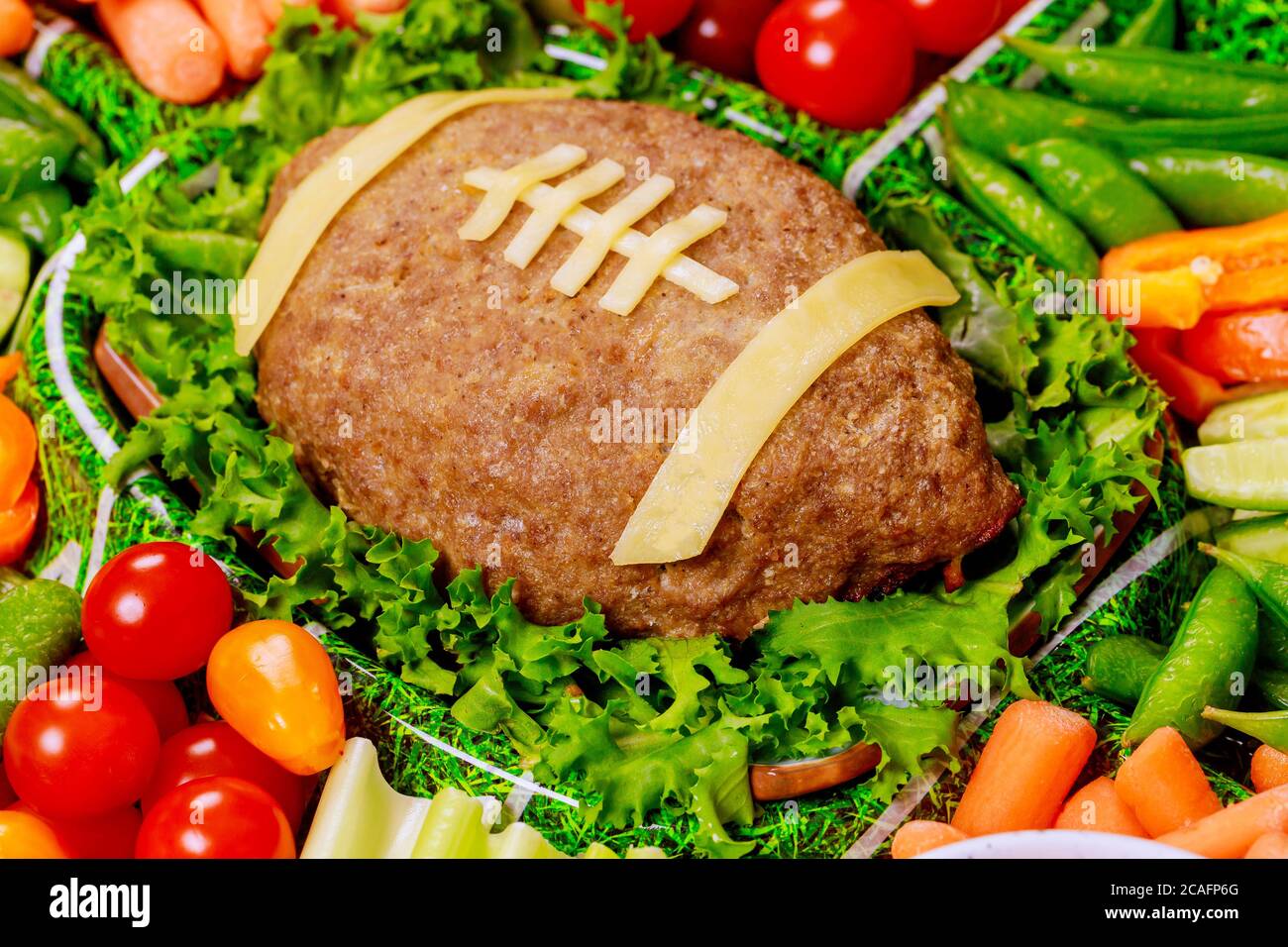 Healthy vegetable platter with meatloaf like a football for american ...