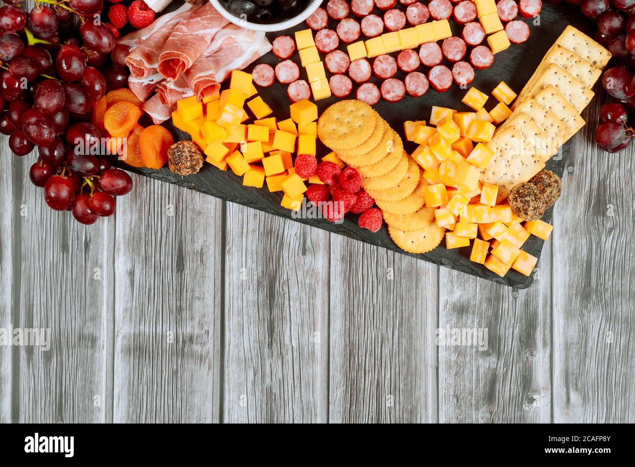 Football made from cheese and sausage for charcuterie board on wooden ...