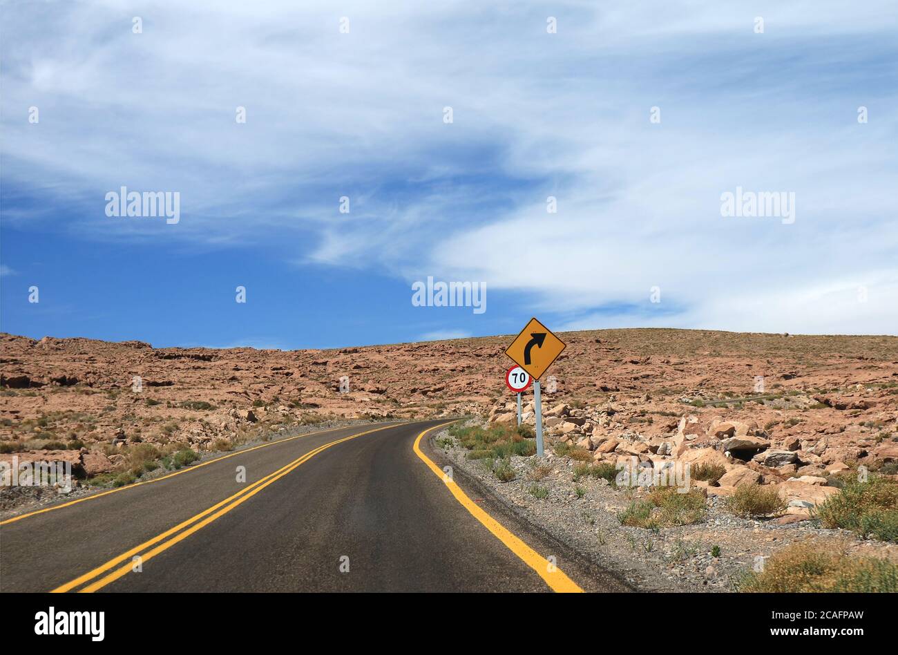 Right Curve and Speed Limit Traffic Signpost on the Empty Road in ...