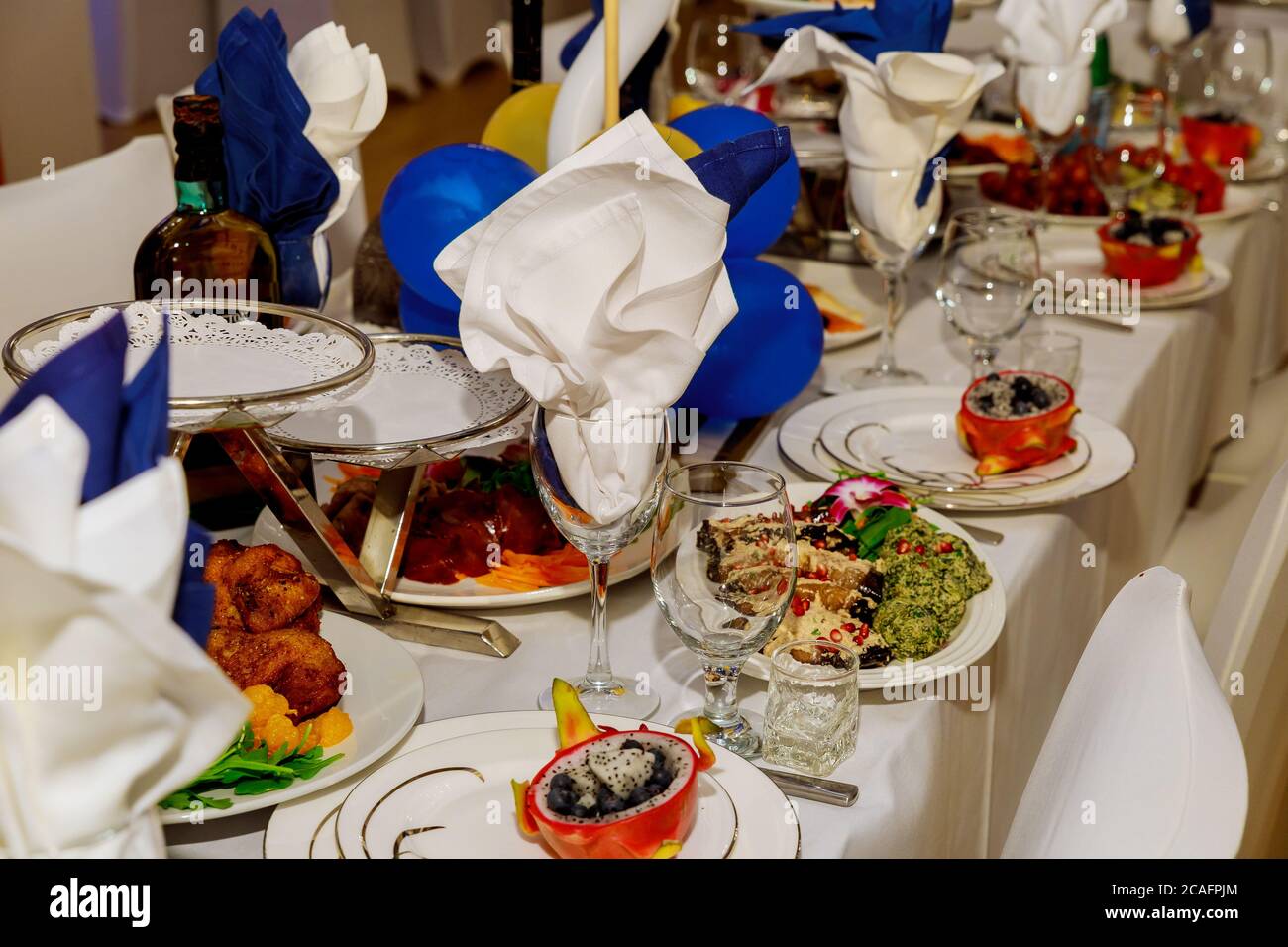 Festive dinner table setting with meal in restaurant Stock Photo - Alamy