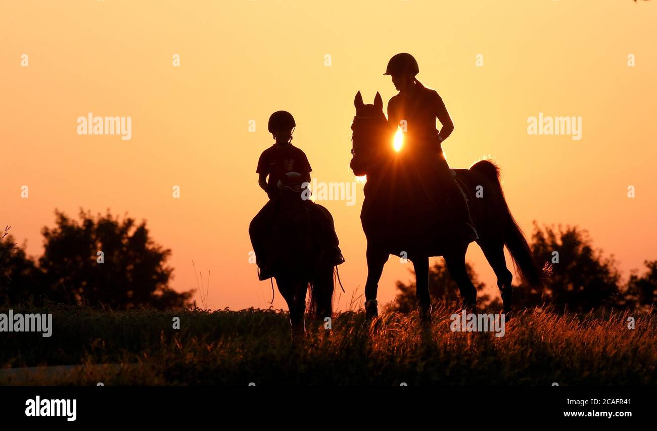 Offingen, Germany. 07th Aug, 2020. Two girls are out with their horses ...