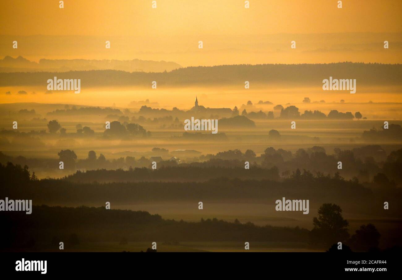 Offingen, Germany. 07th Aug, 2020. A church tower rises from the ground ...