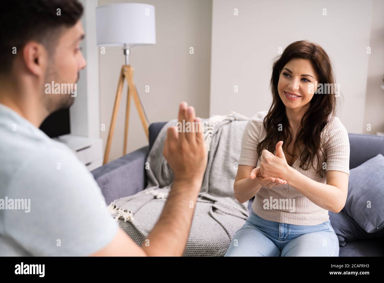 Young Deaf People Using Sign Language At Sofa Stock Photo - Alamy