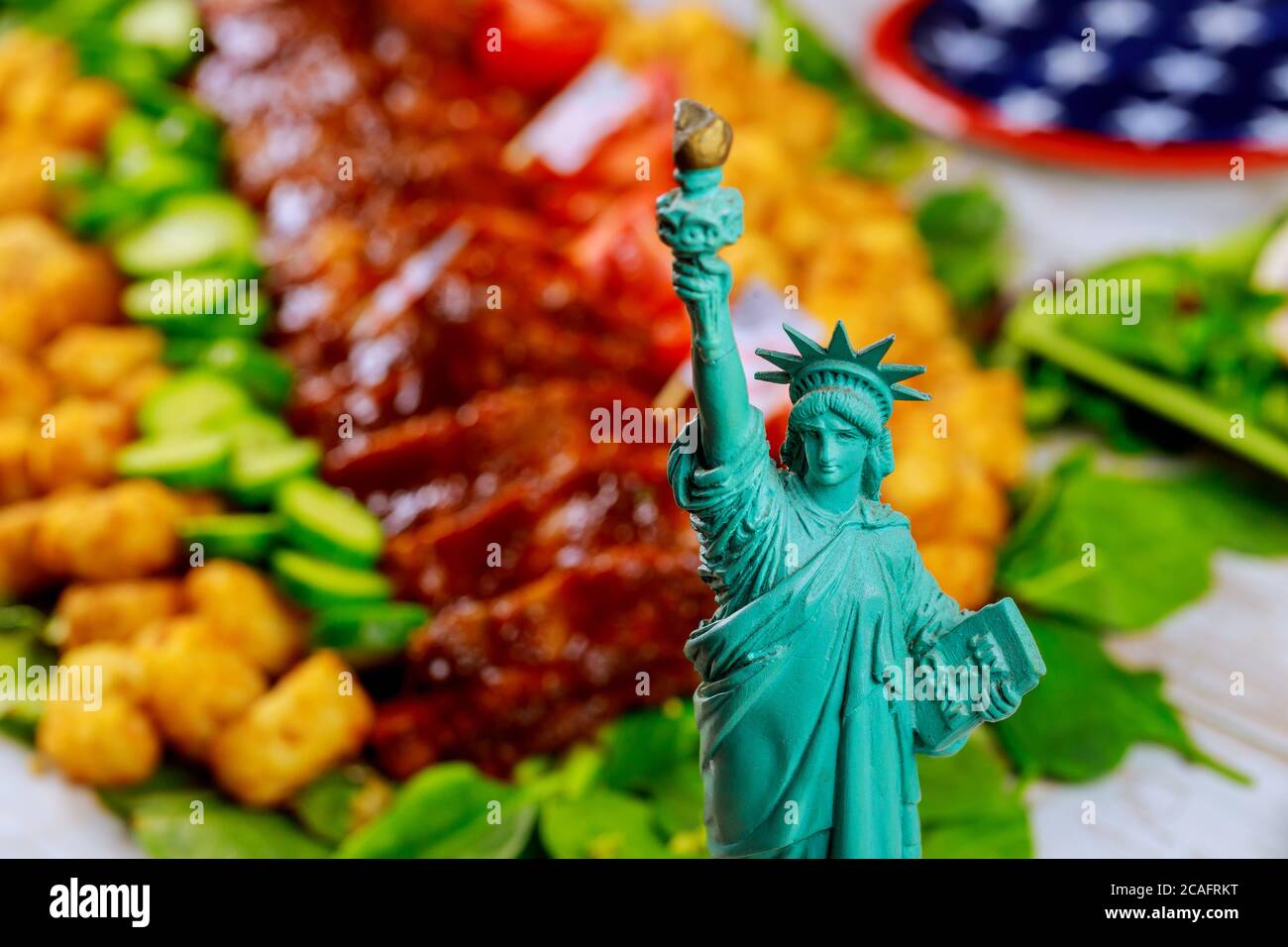 Statue of Liberty and blurry party table with meat and vegetable not in ...