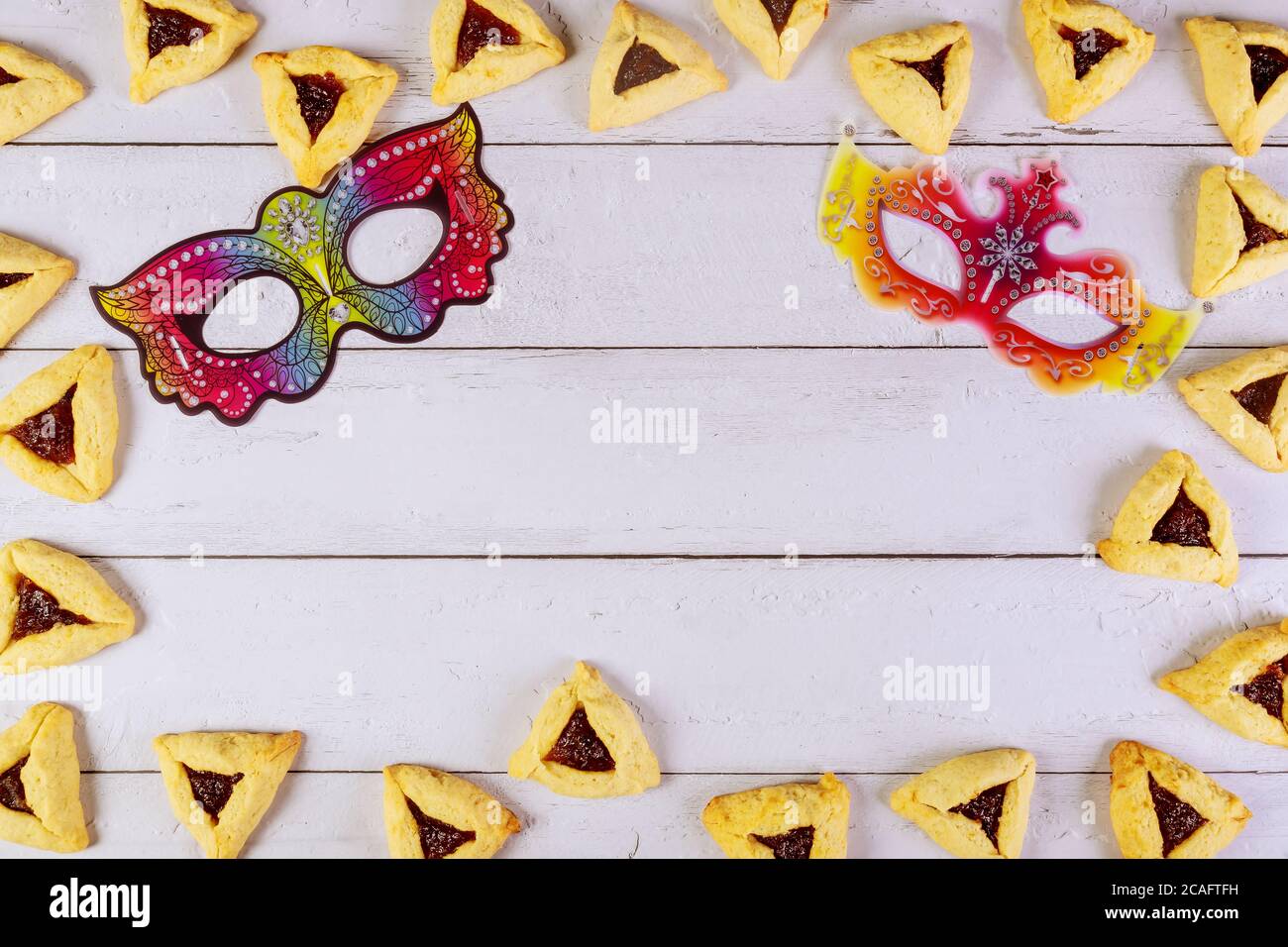 Purim background with masks and hamantaschen triangle cookies Stock ...