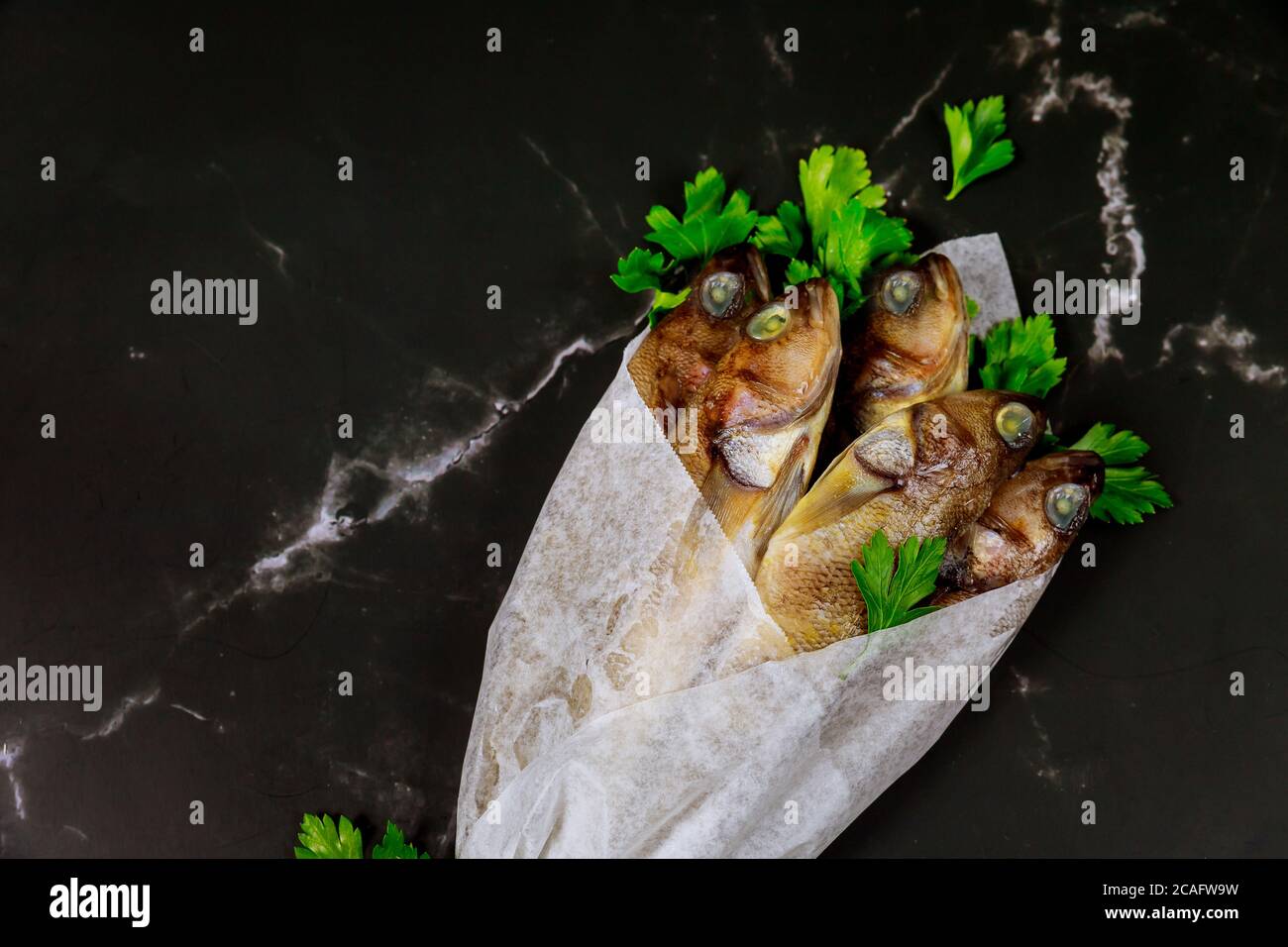 Whole fish wrapped in paper hi-res stock photography and images - Alamy