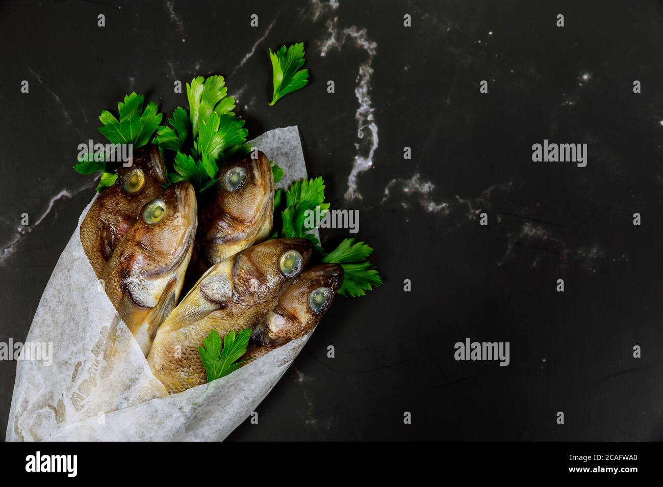 Whole fish wrapped in paper hi-res stock photography and images - Alamy