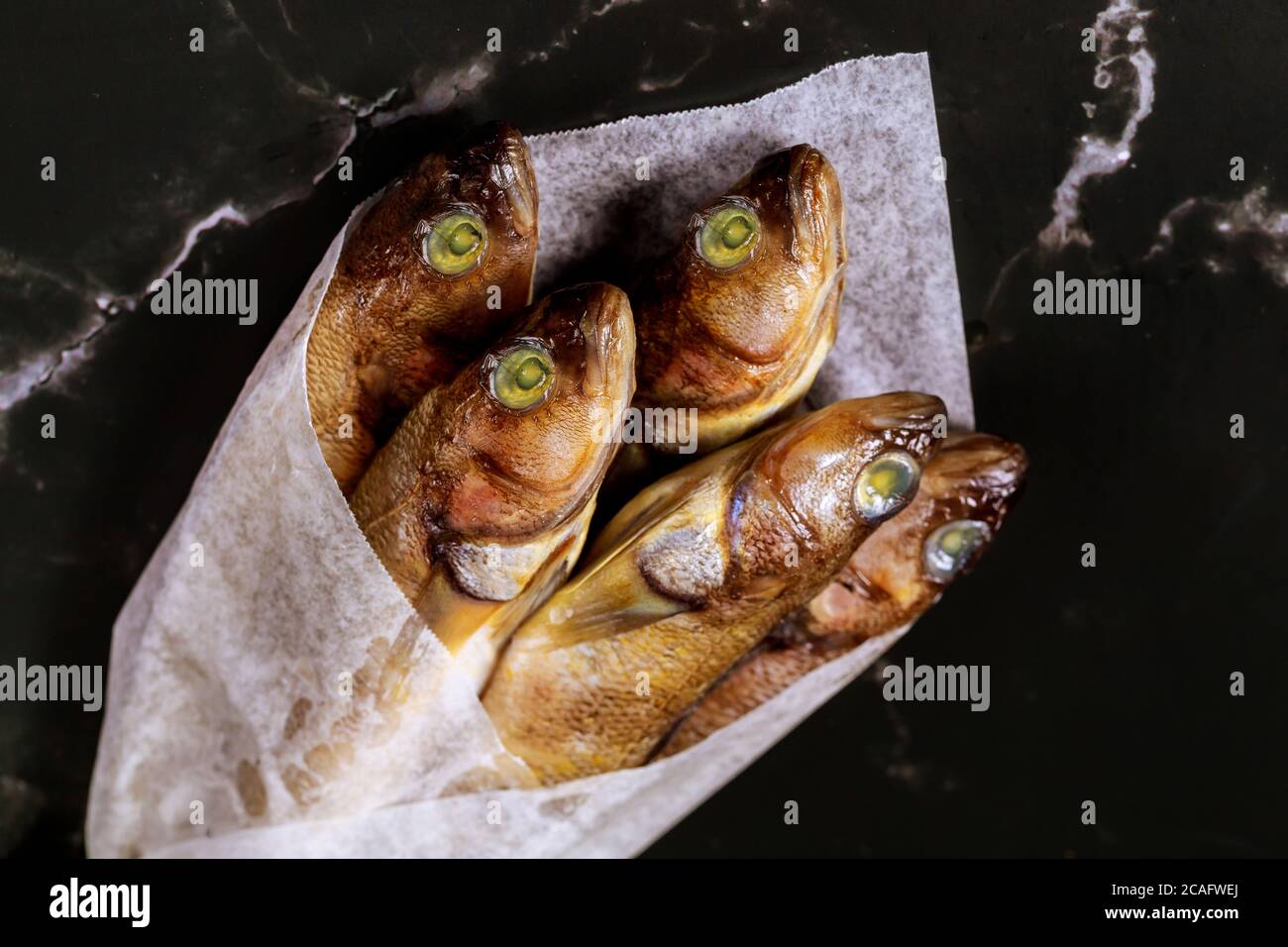Whole fish wrapped in paper hi-res stock photography and images - Alamy