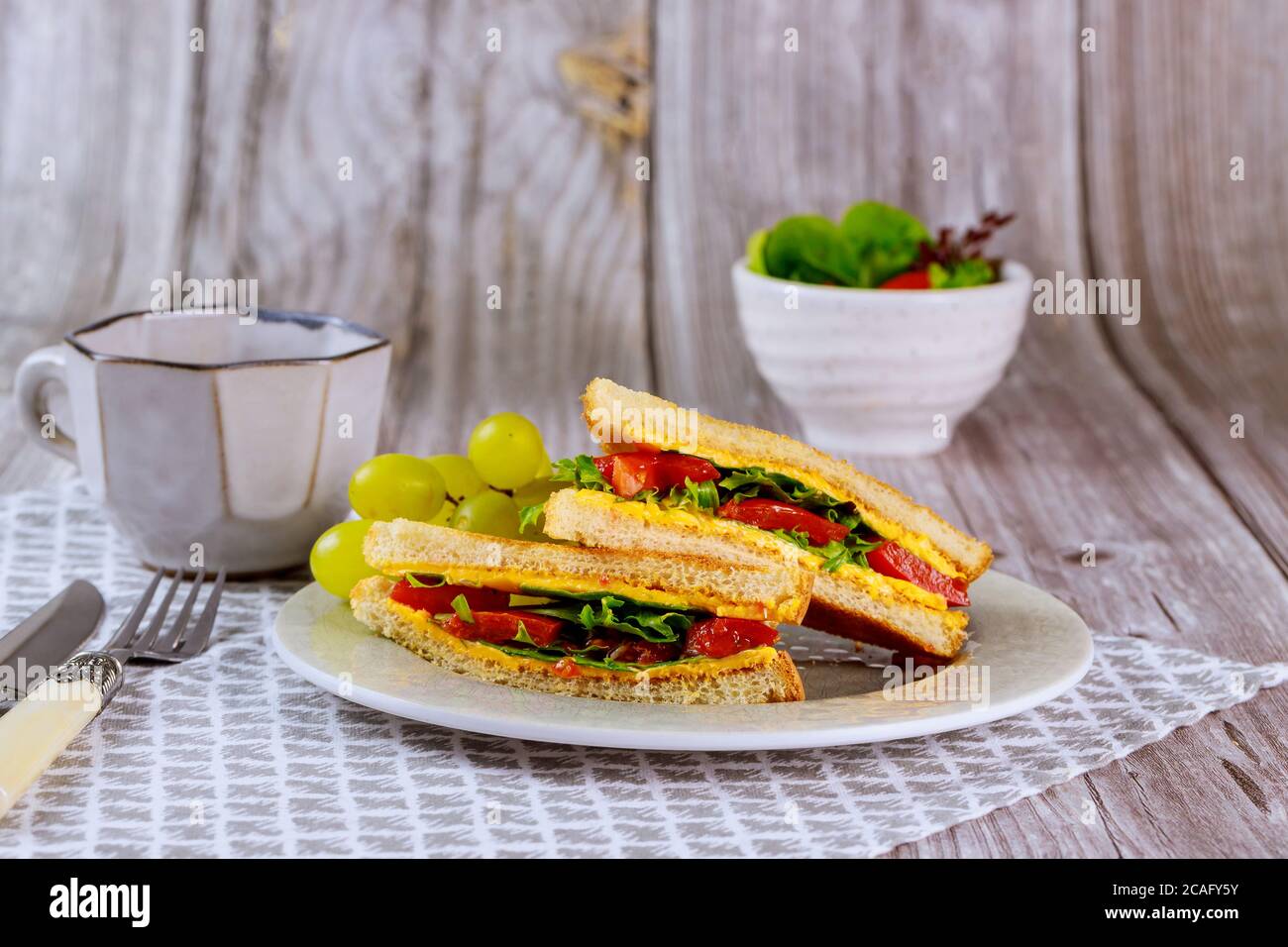 Toast with melted american cheese, spinach, tomato and grape for ...