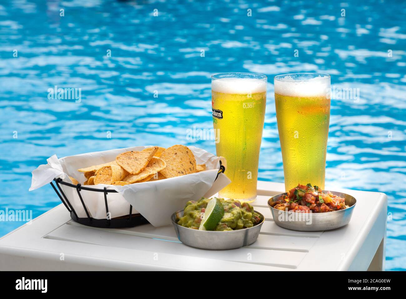 nacho and beer in swimming pool Stock Photo - Alamy