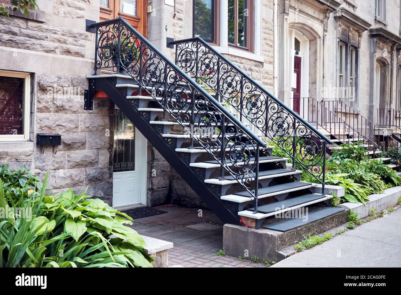 Stone facades and the exterior entrance stairs of row houses in ...