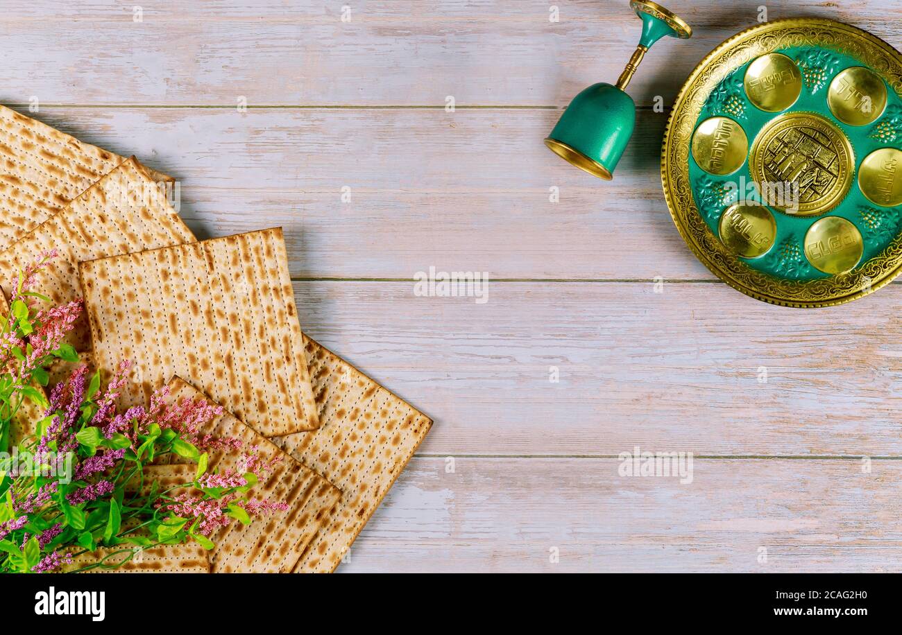 Jewish matzah, kiddush with wine cup and seder with text in hebrew egg ...