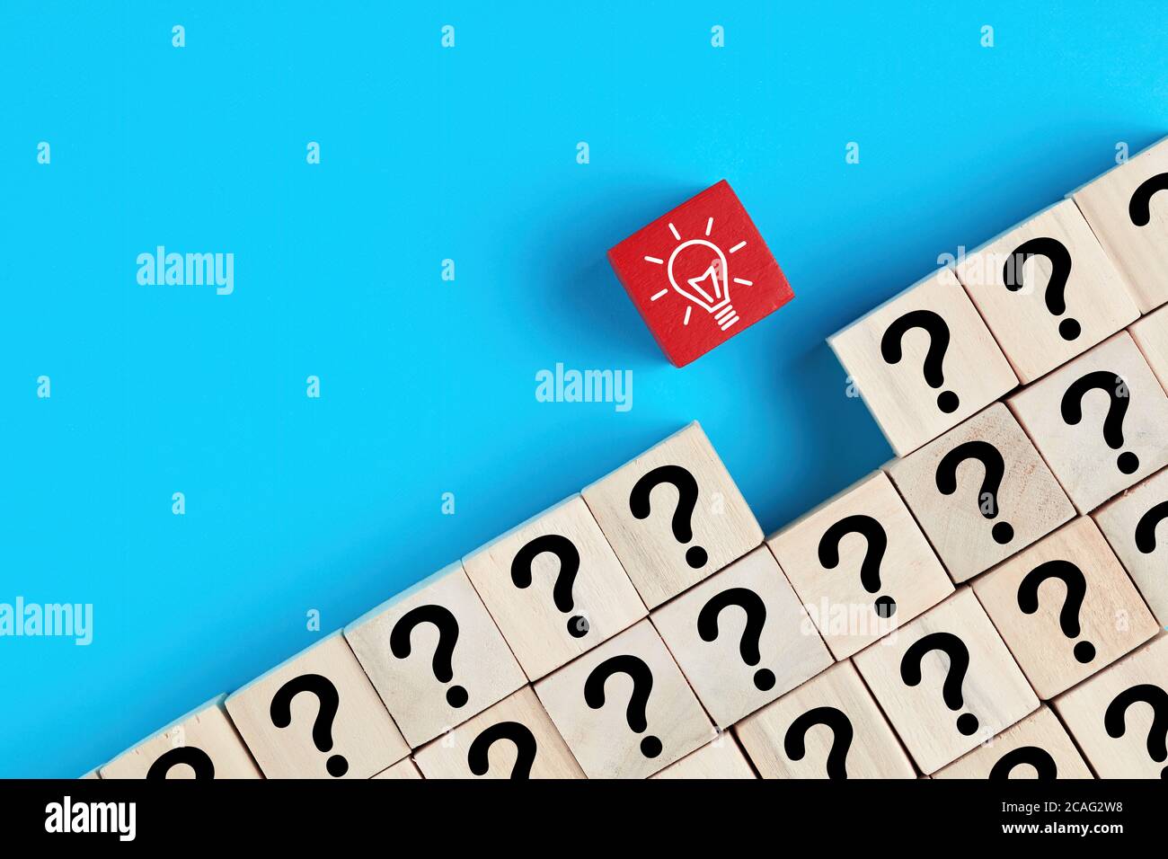 Creative idea, solution or problem solving concept. Question mark and light bulb icons on wooden ...