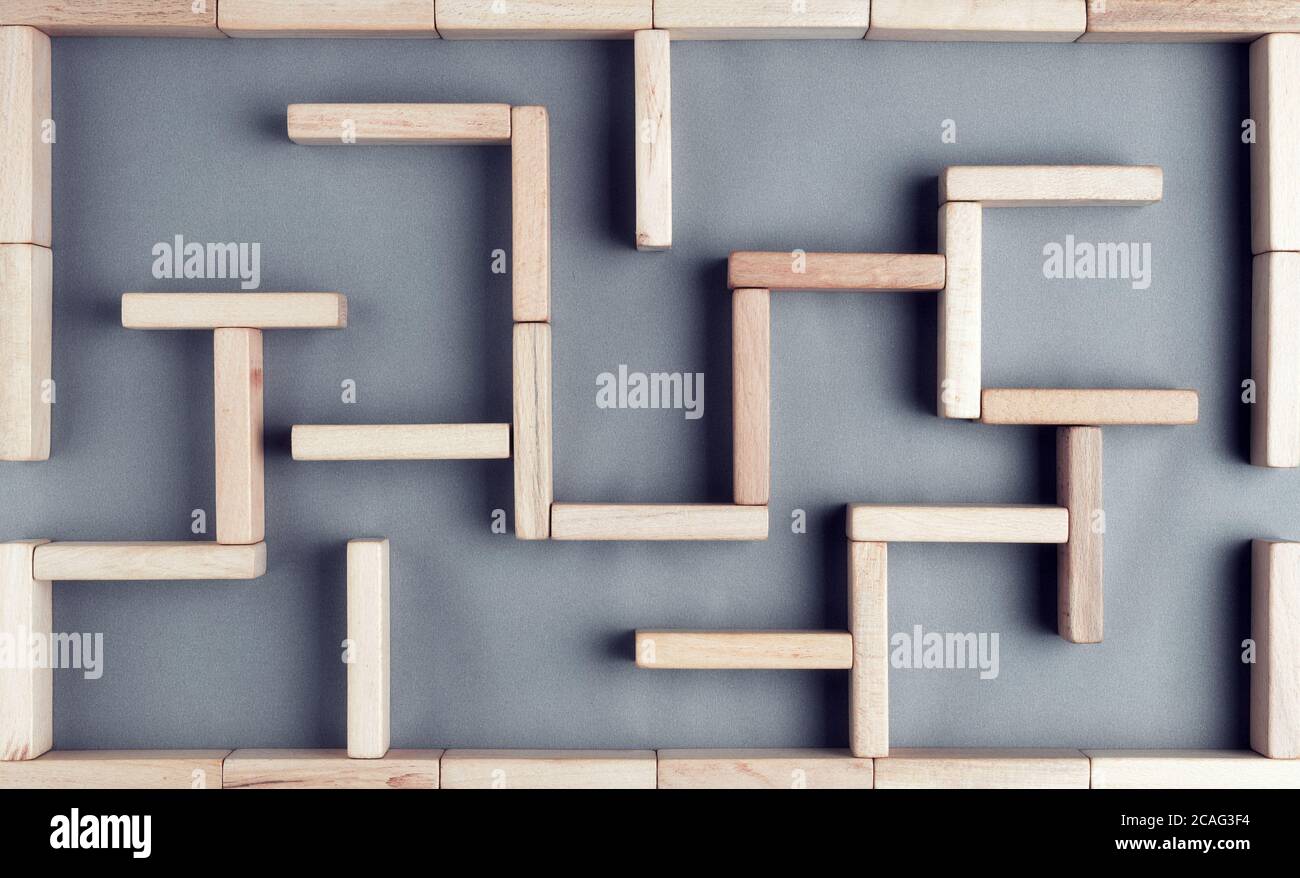 Overhead view of a maze or labyrinth made with wooden blocks. Business strategy, solution ...