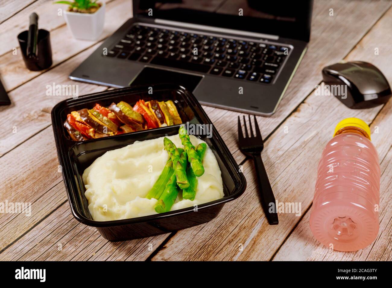 Lunch box container with mashed potato, asparagus and vegetables on ...