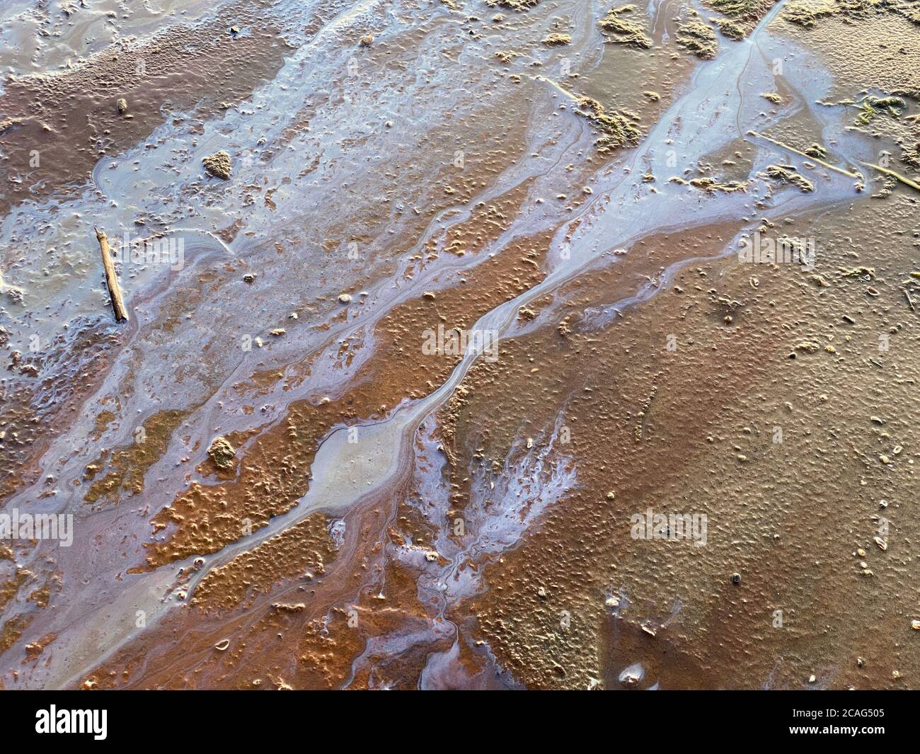 oil stains on beach sand environmental disaster Stock Photo - Alamy