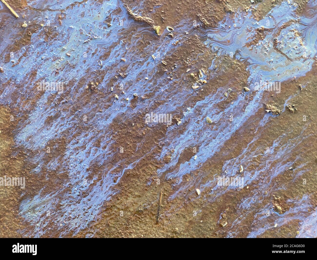 oil stains on beach sand environmental disaster Stock Photo - Alamy