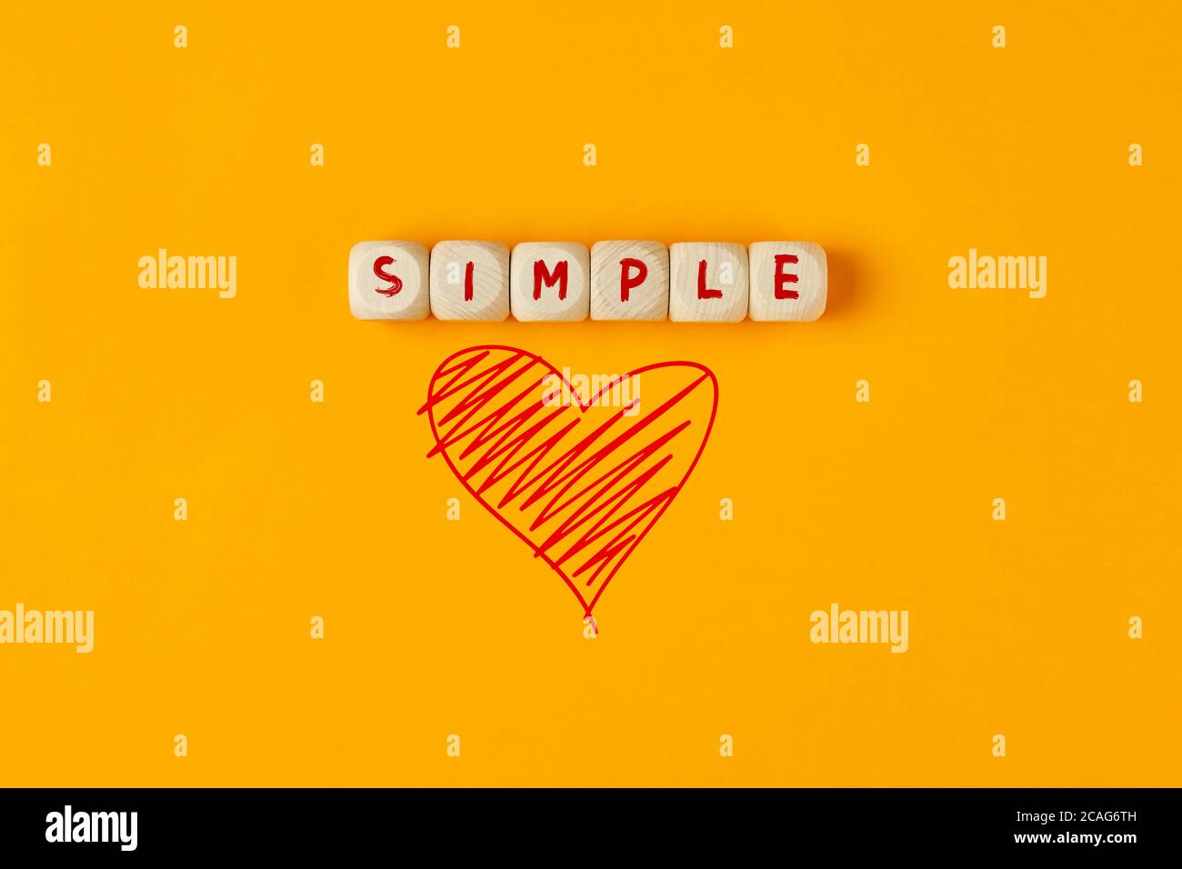 The word simple written on wooden blocks with hand drawn heart shape on ...