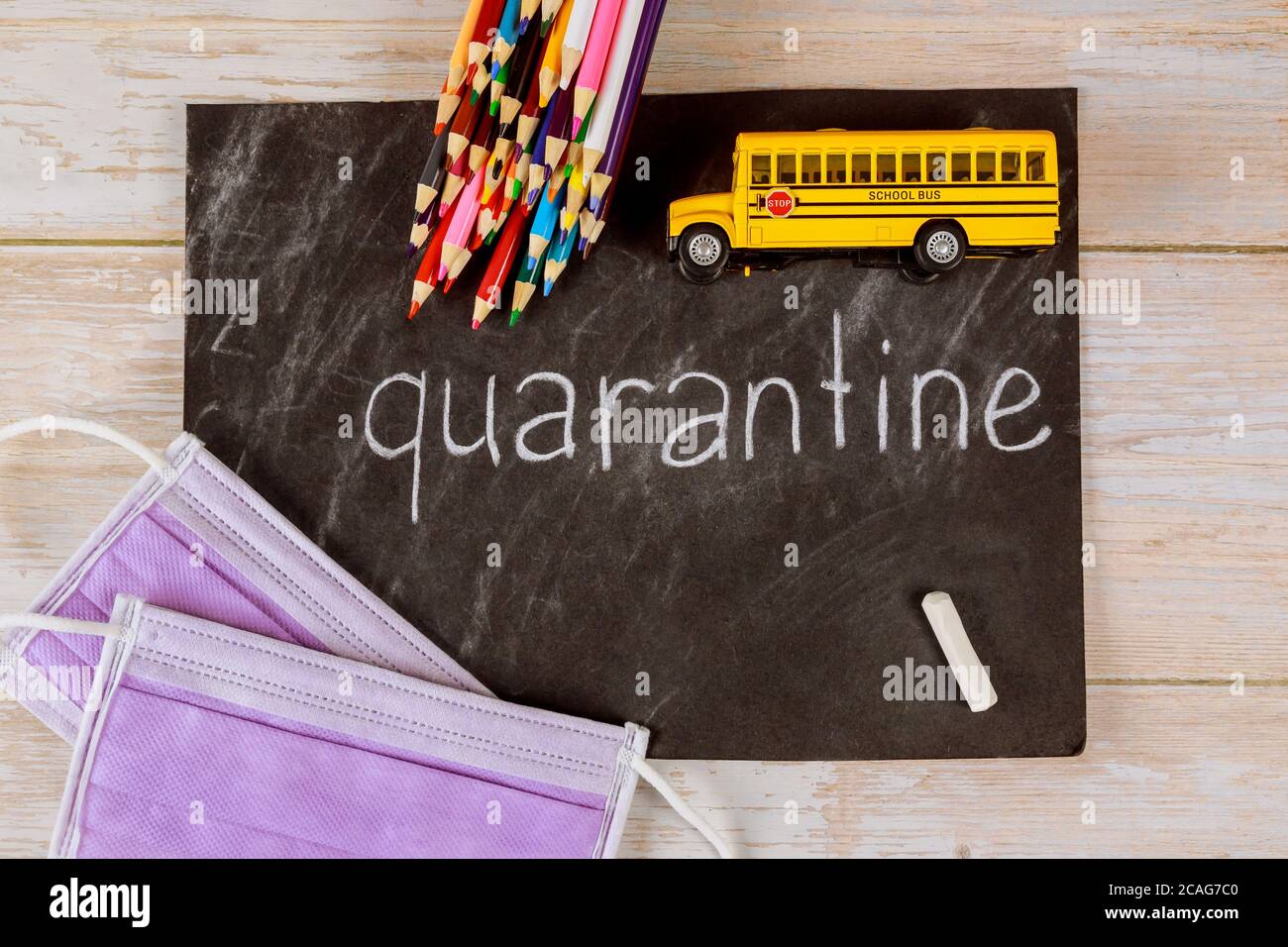 Quarantine in school for student concept. Chalkboard, color pencils and ...