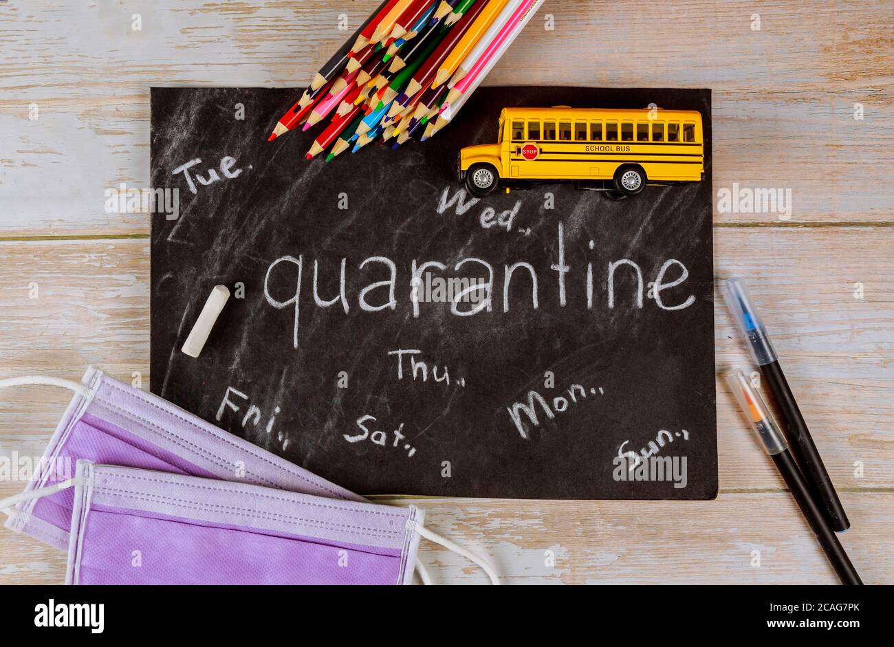 Chalkboard, color pencils and bus toy. Quarantine in school for student ...
