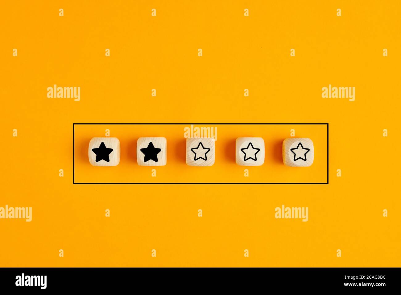 Wooden cubes with two stars out of five. Concept of poor service rating ...