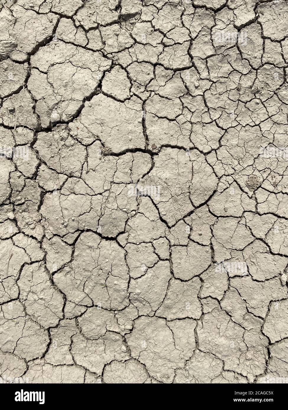 dried cracked soil background top view Stock Photo - Alamy