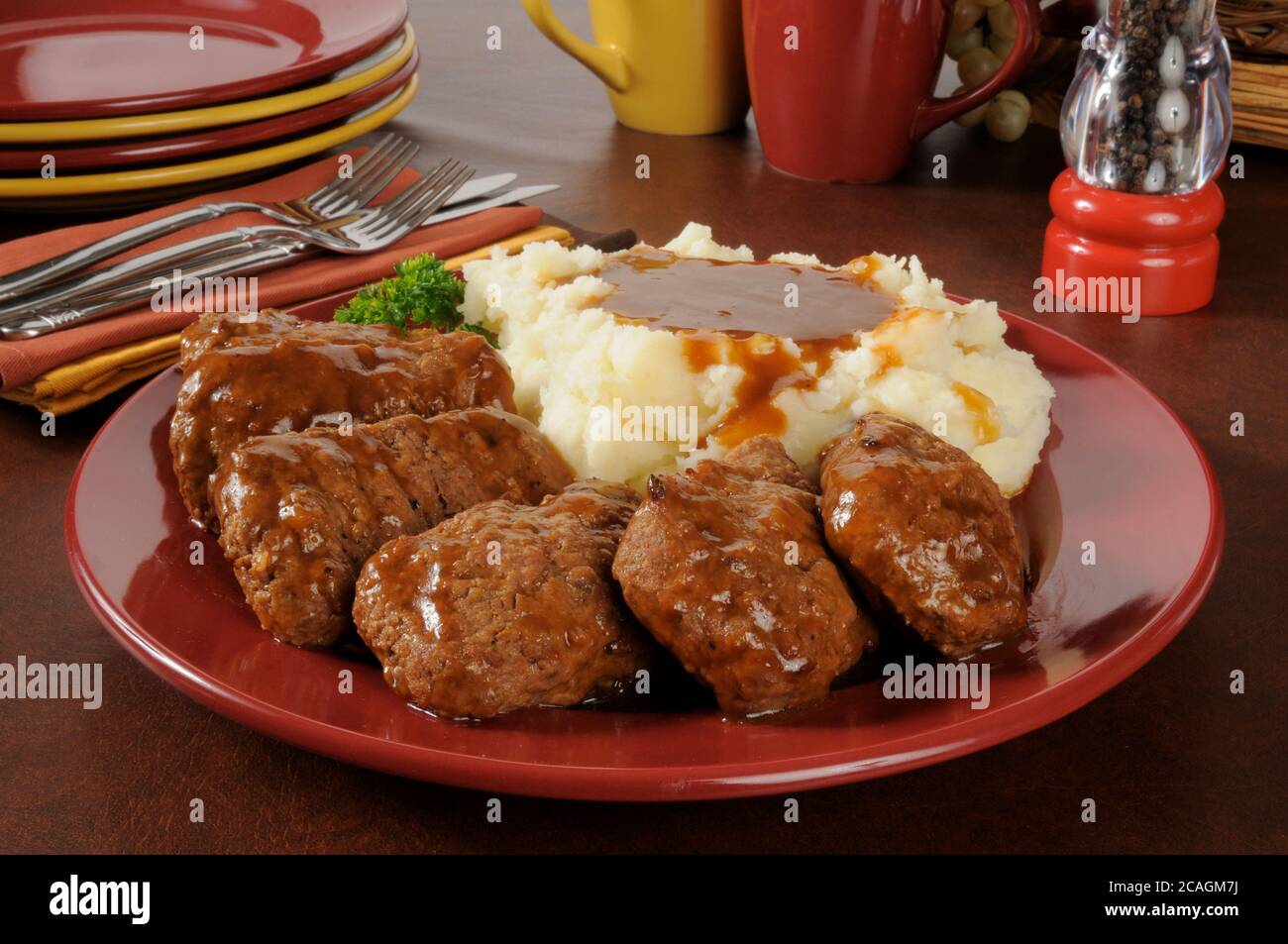 A platter of meatloaf with mashed potatoes and gravy served family ...