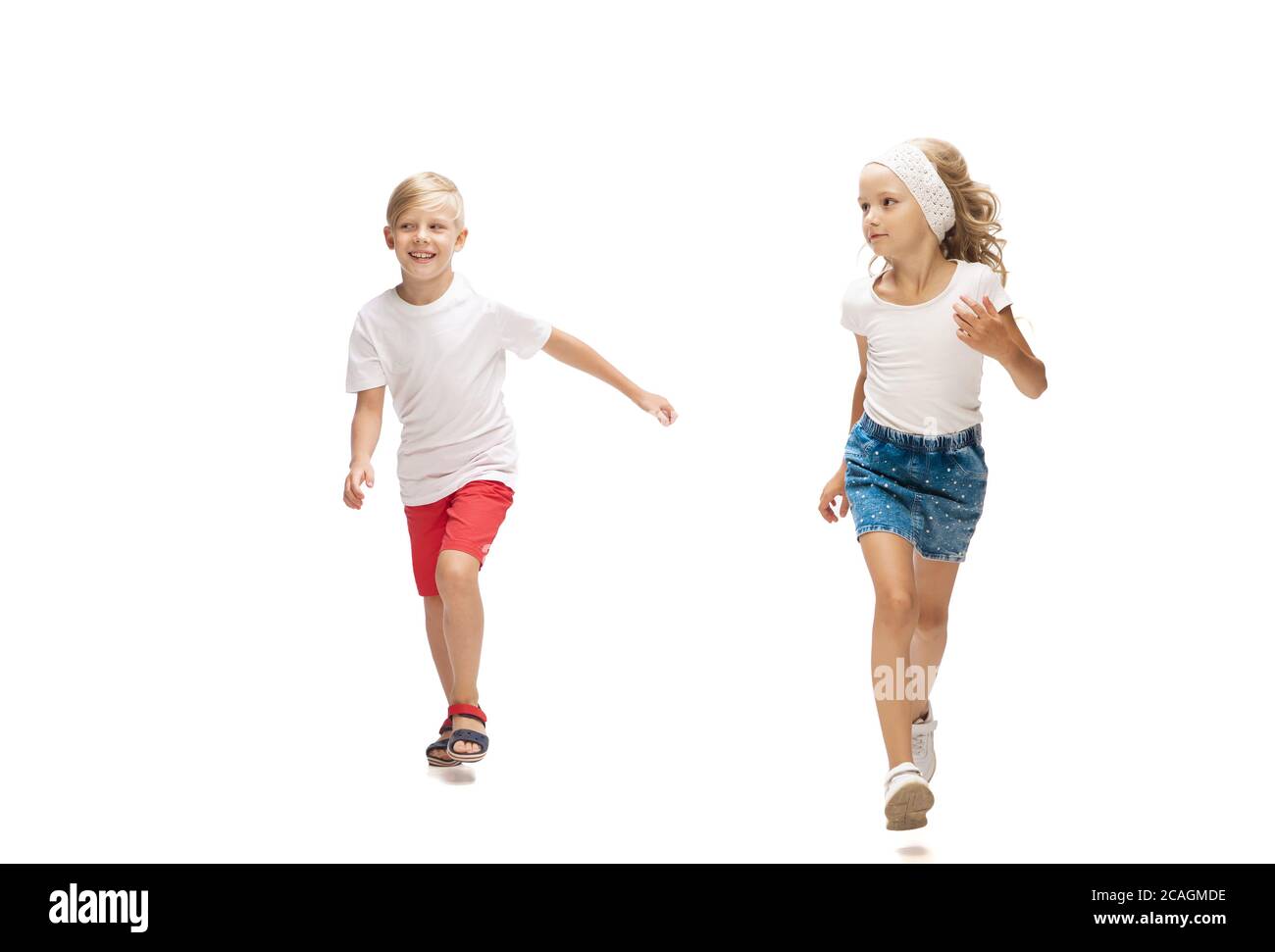 Happy kids, little and emotional caucasian boy and girl jumping and ...