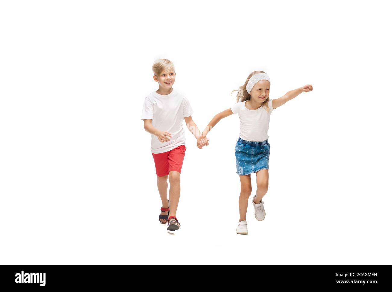 Happy kids, little and emotional caucasian boy and girl jumping and ...