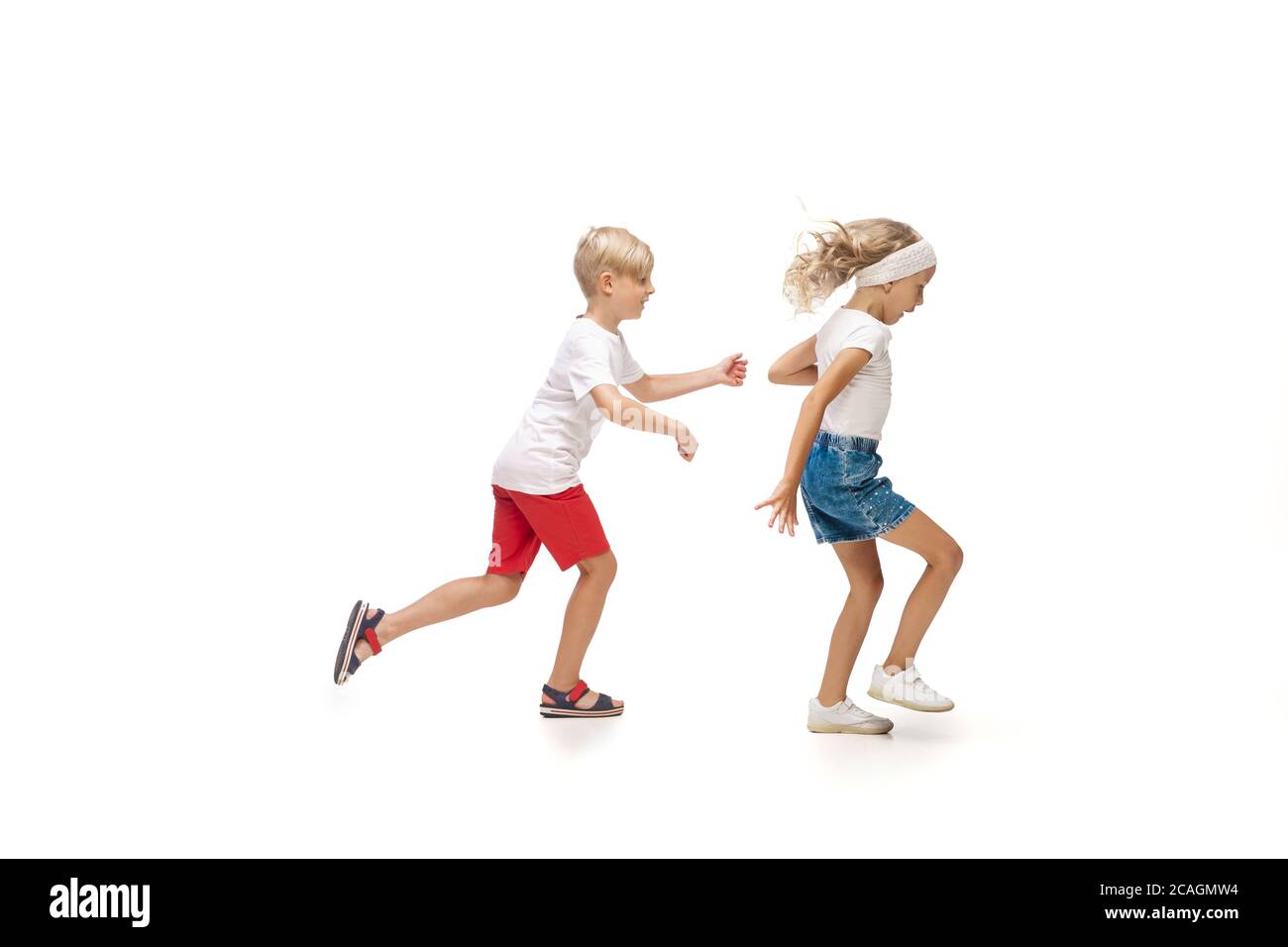 Fun. Happy kids, little emotional caucasian boy and girl jumping and ...