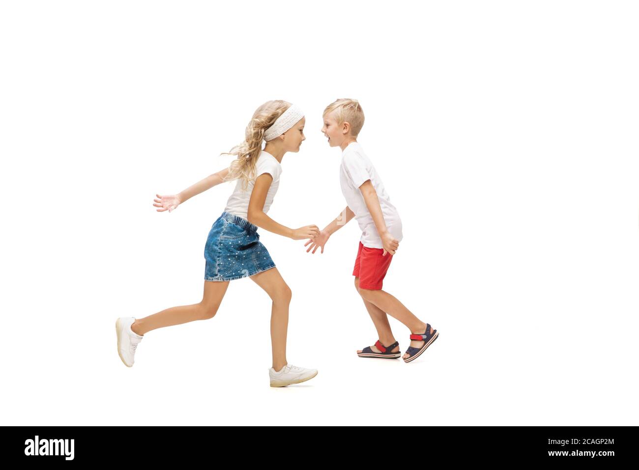 Friendship. Happy kids, little emotional caucasian boy and girl jumping ...