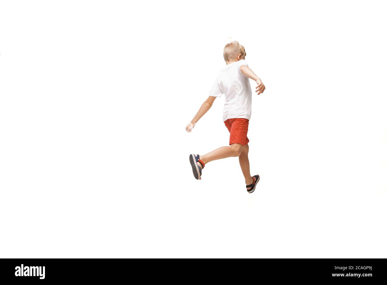 Energy. Happy kids, little and emotional caucasian boy jumping and ...