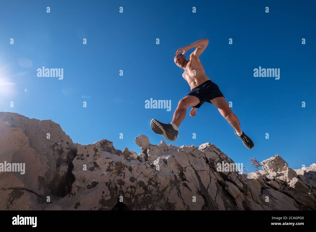 Active fast running mountain sweaty body muscular sky runner jumping ...