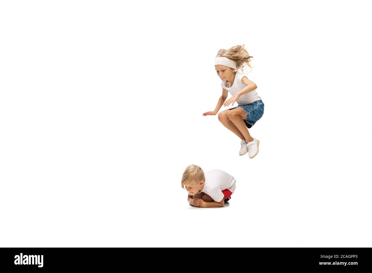 Playing. Happy kids, little emotional caucasian boy and girl jumping ...