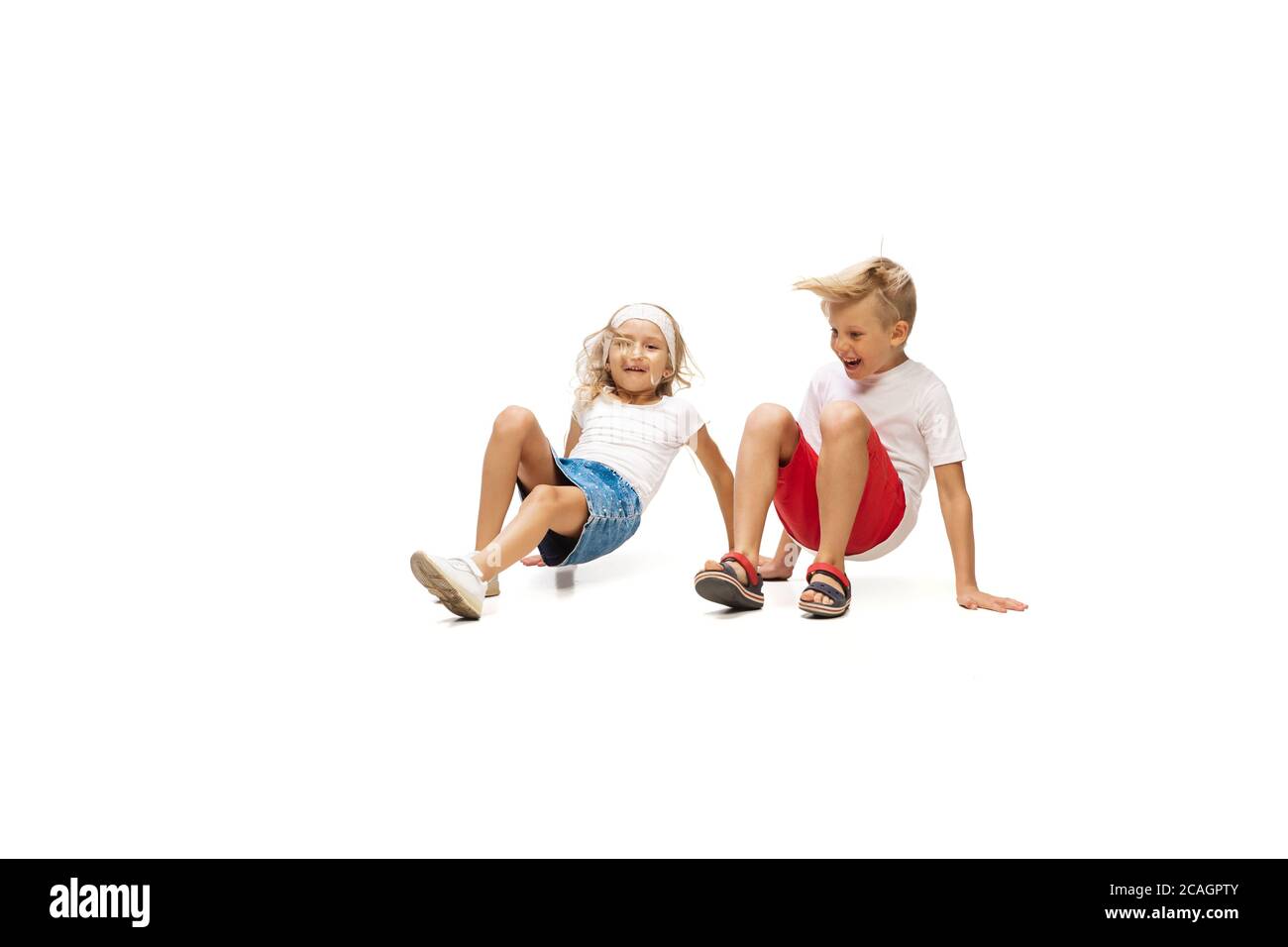 Playing. Happy kids, little emotional caucasian boy and girl jumping ...
