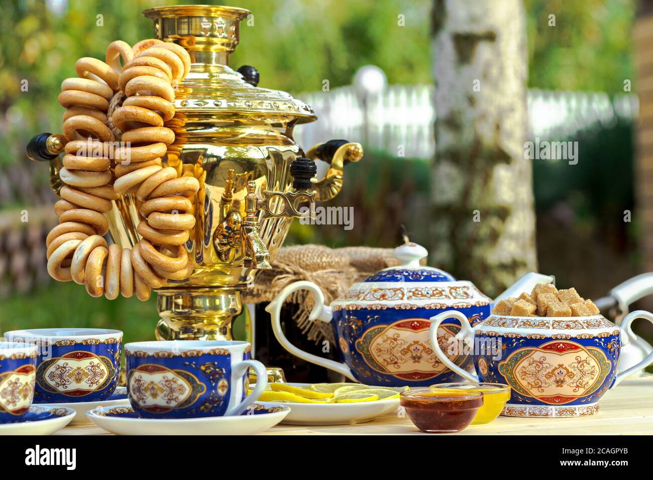 Golden samovar on the table with tea set Stock Photo - Alamy