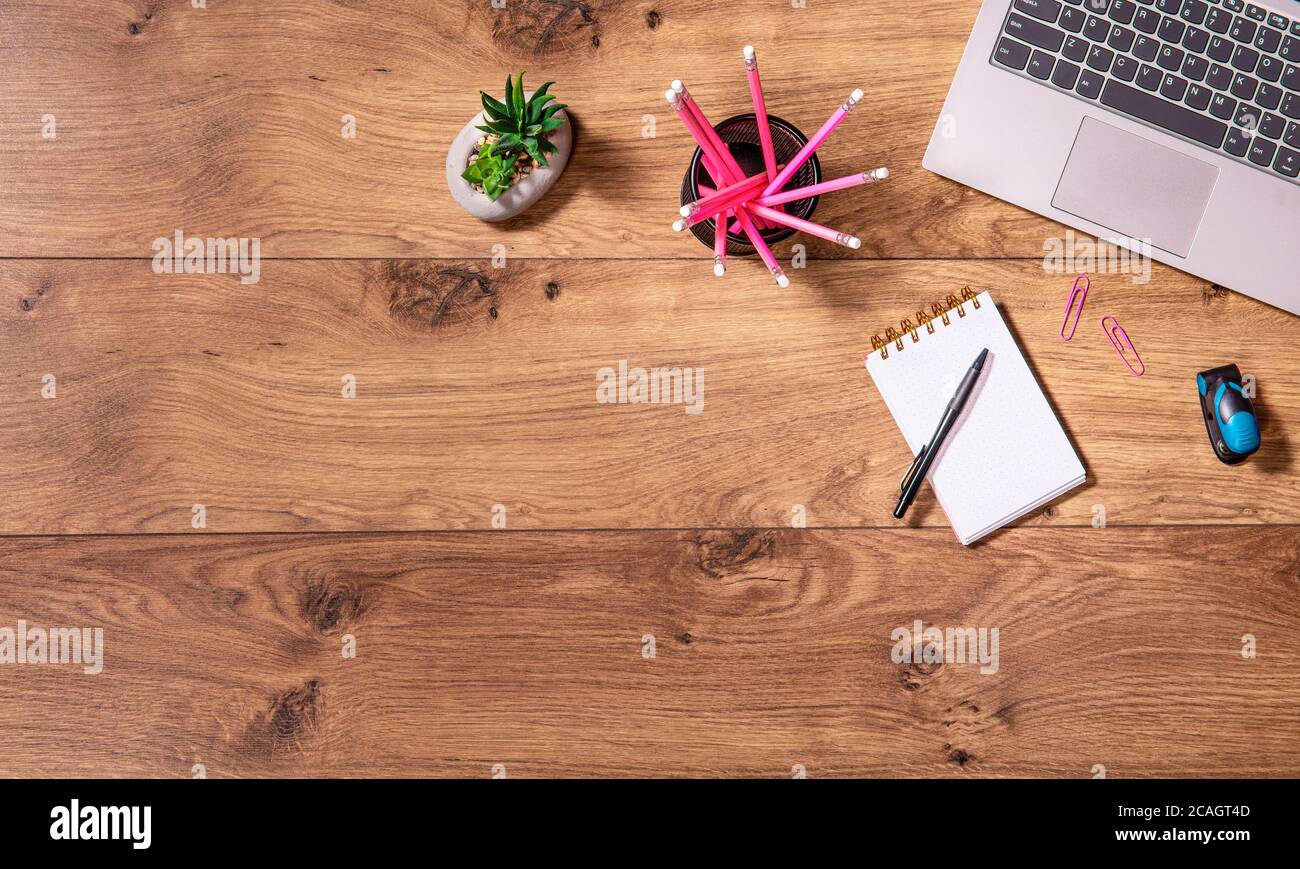 Office table top view with laptop, pencils and notepad. Workplace view ...