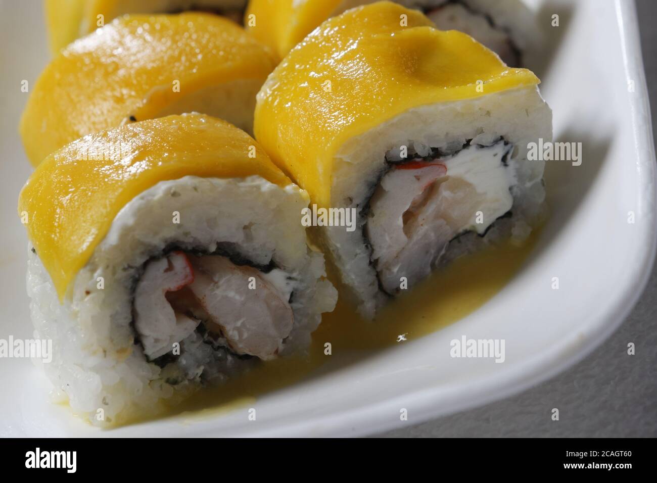 Closeup shot of the delicious sushi rolls with yellow pickled radish on ...